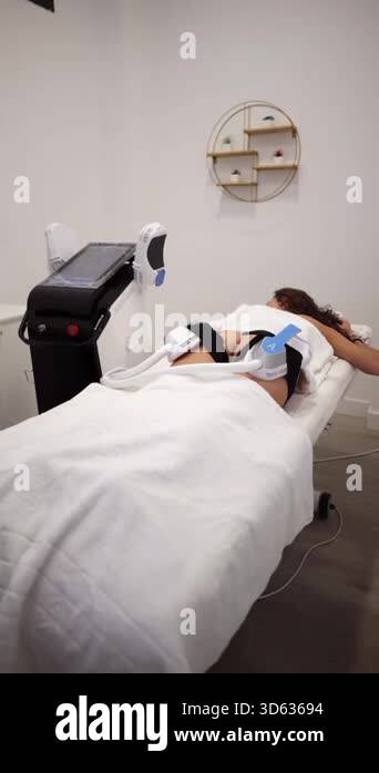 Young woman relaxing on a treatment table while receiving a non ...