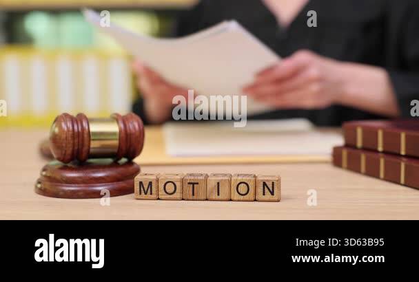 In a busy courtroom, a judge prepares important documents. The gavel ...