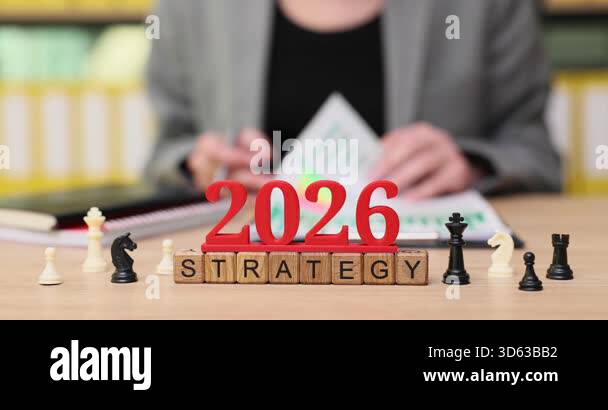 Hands arrange chess pieces while focusing on a plan for the year 2026 ...