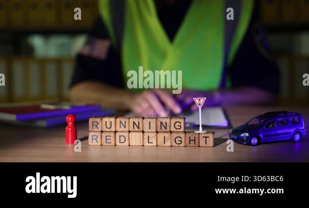 A person in a safety vest interacts with toy cars and colorful blocks ...