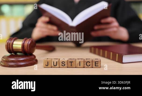 In a calm setting filled with books, a judge contemplates justice. Eyes ...