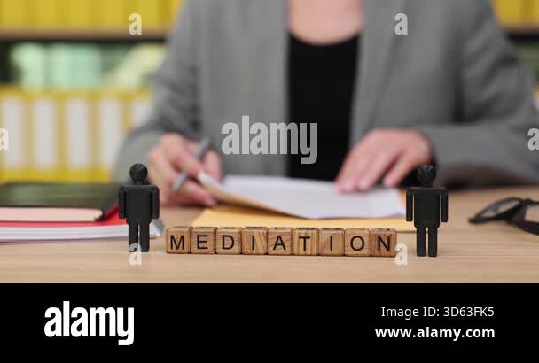 In a bright office, a mediator sits at a desk with tiny figures ...