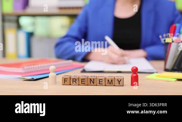 In a lively study area, a person joyfully assembles letters to spell ...