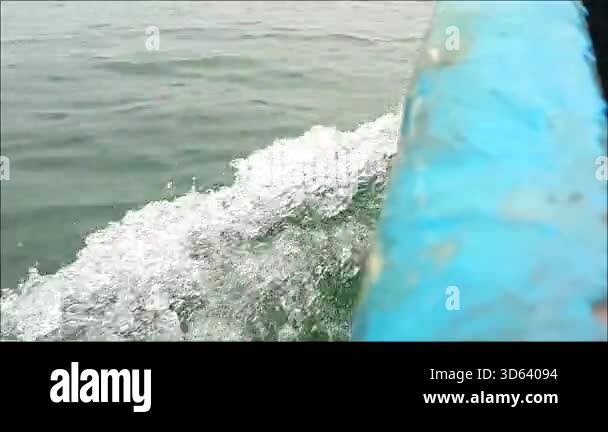 Close-up footage of water splashing beside a traditional wooden fishing ...