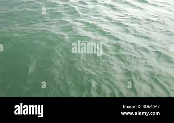 Sea water slowly rising during high tide, with gentle waves moving ...