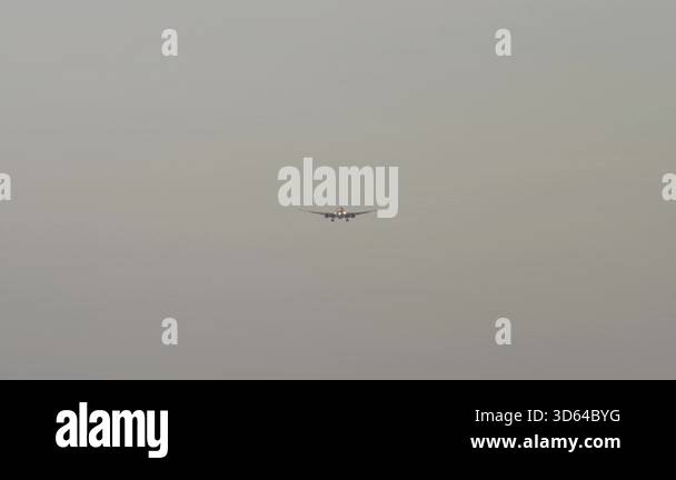 Front view of a jet airplane approaching for landing. Unmarked ...