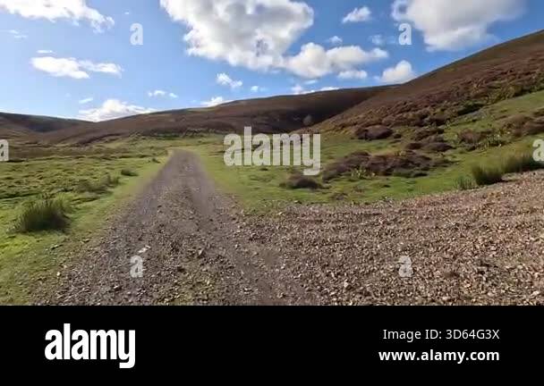 Hillwalker traversing upland moorland paths in the Lammermuir Hills of ...