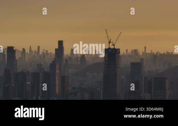 Hazy aerial view of a massive modern city skyline dominated by tall ...