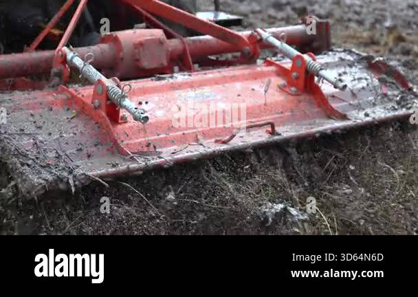 Tractor plowing muddy rice field, mud in the paddy, showing soil ...
