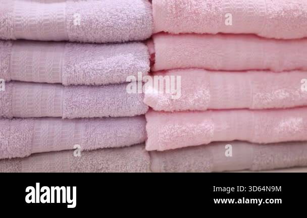 Towels neatly stacked on shelf in department store, warm and cozy ...