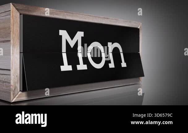 Wooden flip calendar changing abbreviated days of a week from Sunday to ...