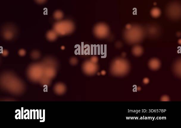 Glowing orange bokeh particles floating in dark space. Abstract warm ...