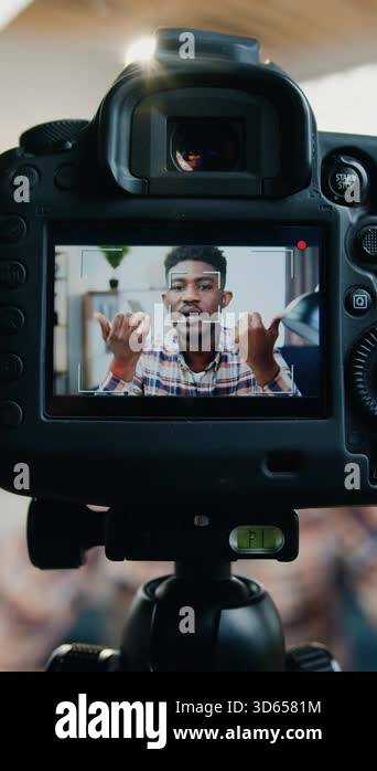 View through lens camera where good-looking smiling confident young ...