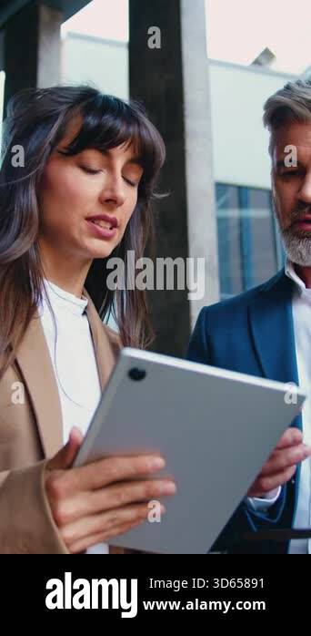 Close up of two business people, a man and a woman in formal attire ...
