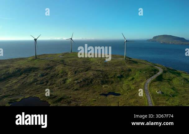 Captivating views of the Faroe Islands showcase towering wind turbines ...