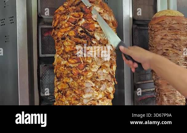 A chef slicing perfectly seasoned meat for a delicious kebab dish Stock ...