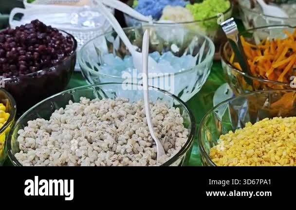 Fresh coconut milk ice cream dessert served in a natural coconut shell ...