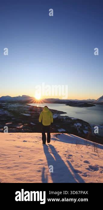 Enjoying the summit in the icy North Norwegian fjords. Celebrating a ...