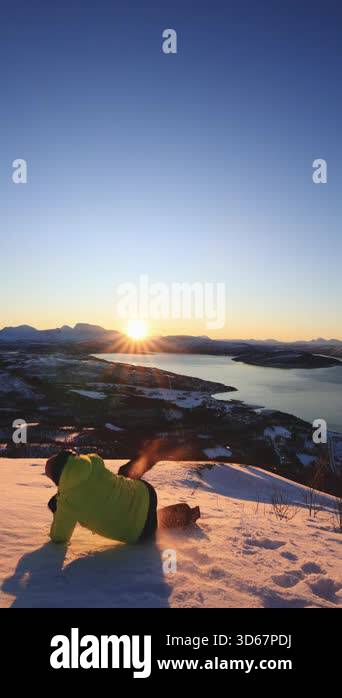 Enjoying the summit in the icy North Norwegian fjords. Celebrating a ...
