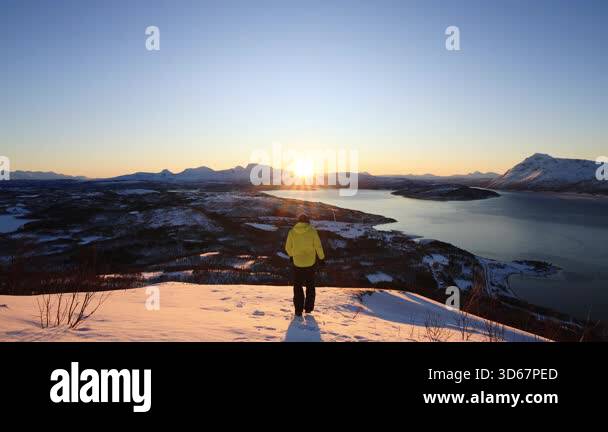 Enjoying the summit in the icy North Norwegian fjords. Celebrating a ...