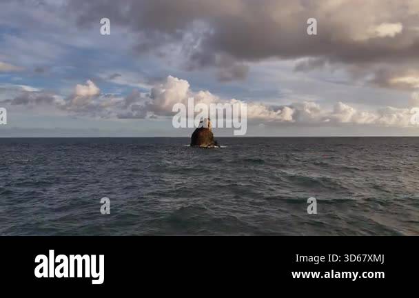 Secluded coastal pinnacle, Sunset over ocean cliffside, Remote sea ...