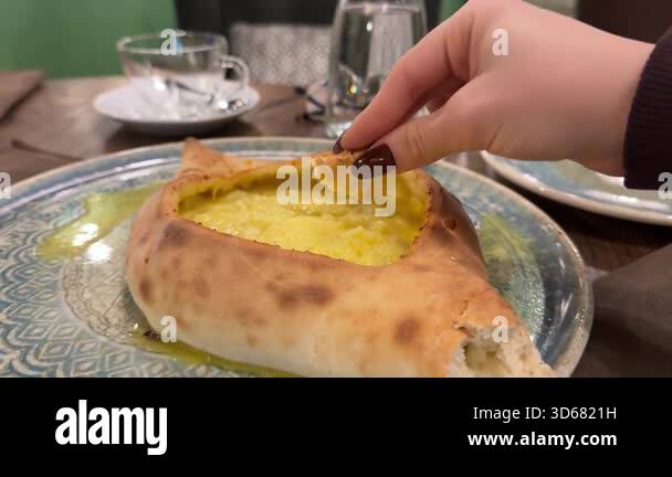 Close-up of traditional Georgian khachapuri cheese bread with eggs on ...