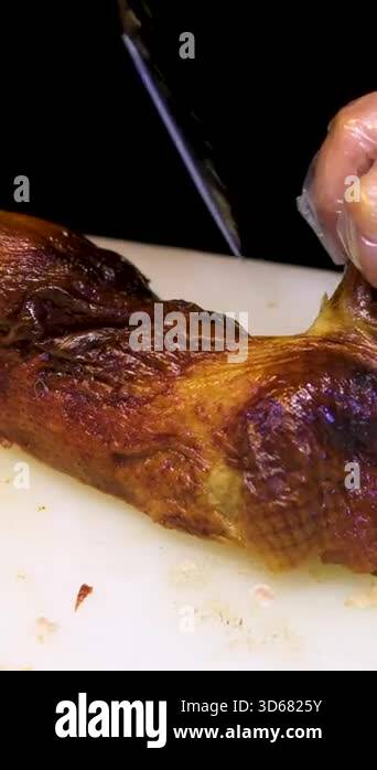 Chinese cook prepares Peking Roast Duck. Peking Duck is a famous duck ...