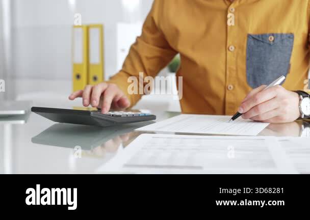 Person reviewing financial spreadsheets and receipts, calculating ...