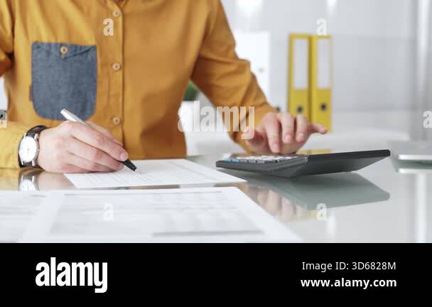 Person reviewing financial spreadsheets and receipts, calculating ...