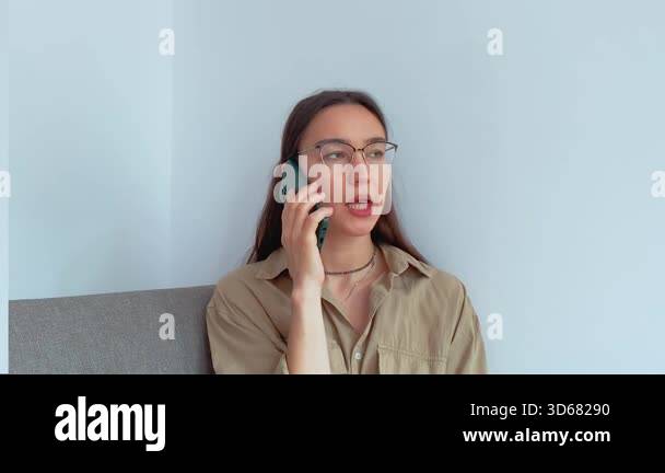 A young attractive girl is talking on a mobile phone with her boyfriend ...