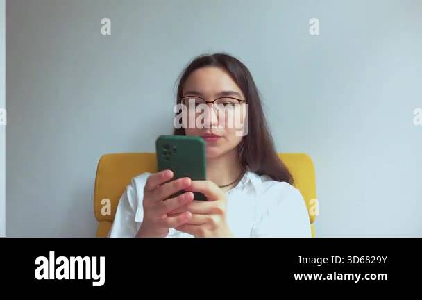 A young attractive girl is talking on a mobile phone with her boyfriend ...