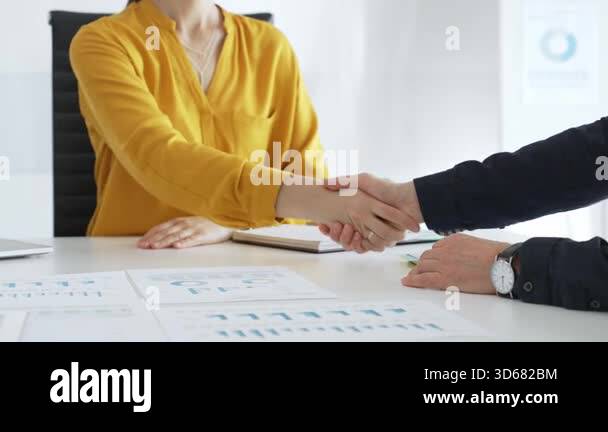 Business partners engaging in a handshake following a successful ...