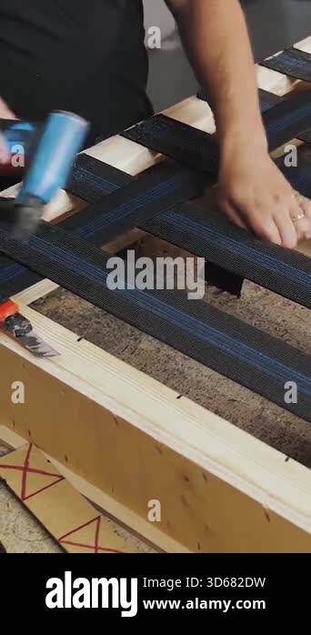 Vertical video. Close-up of hands. Worker making sofa at furniture ...
