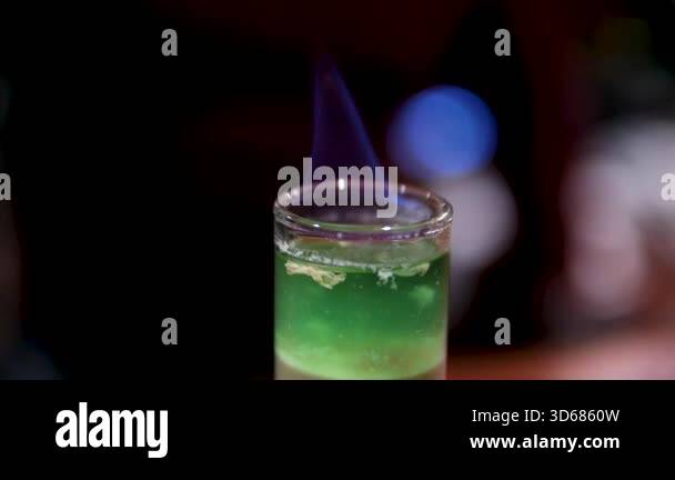 Flaming green cocktail Spectacular footage with the preparation of ...