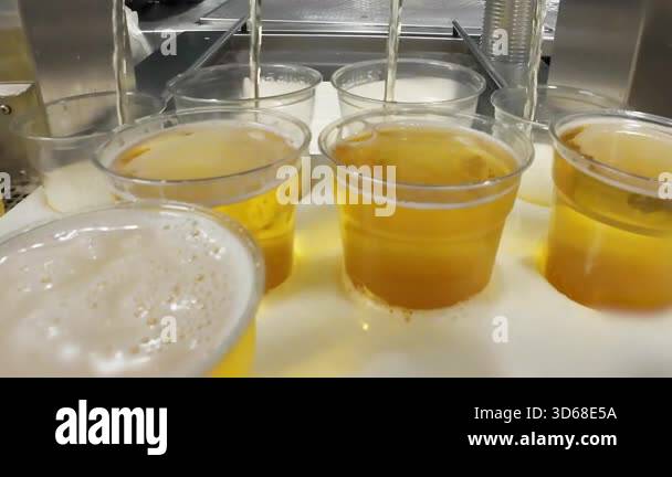 Foaming beer in plastic cups. High quality 4k footage Stock Video ...