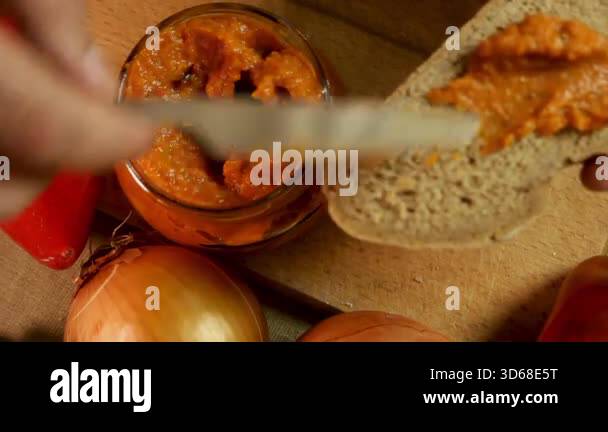 Knife in hand slides across bread, enhancing bread texture with smooth ...