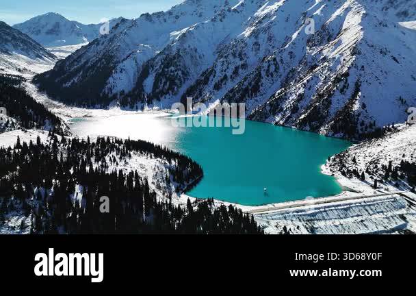 Aerial drone view of Big Almaty mountains lake landscape covered with ...