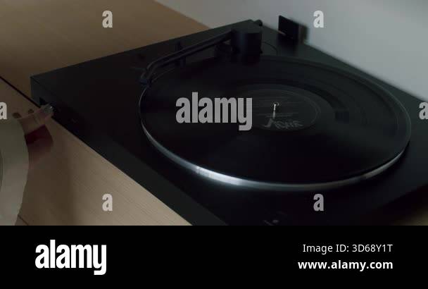 A vinyl record spins on a modern turntable, bringing a vintage vibe to ...