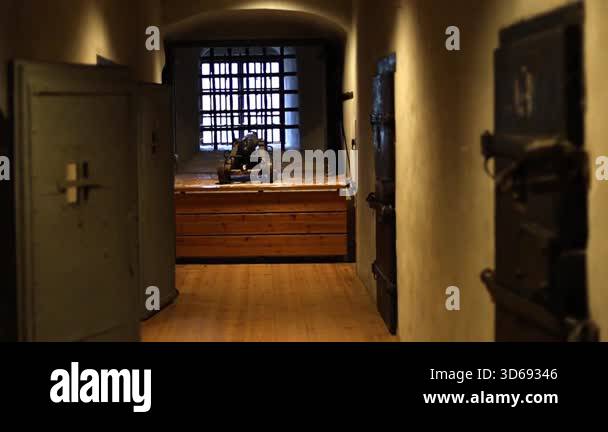 Dark stone prison inside a medieval castle, rusty bars, chains, and ...