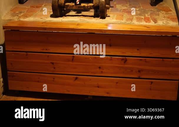 Dark stone prison inside a medieval castle, rusty bars, chains, and ...