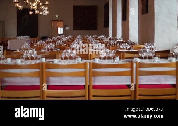 Interior of a medieval castle banquet hall with long wooden tables ...