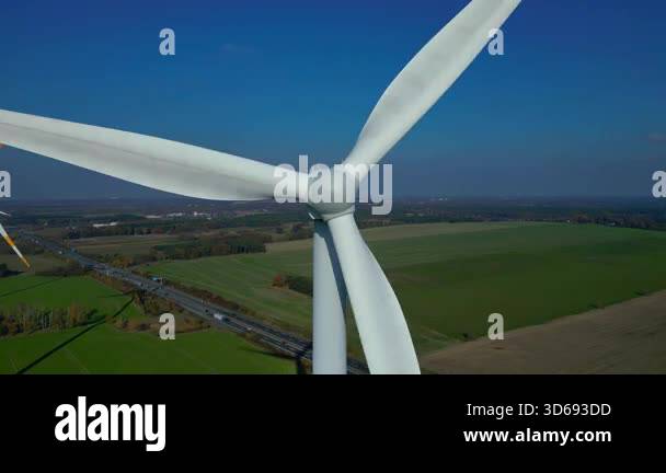 Wind turbine standing in green field next to german autobahn highway ...
