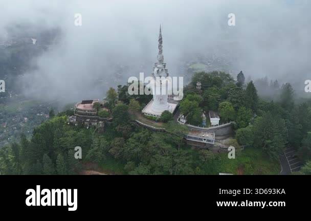Drone flies forward toward the towers upper spire as gusts clear the ...