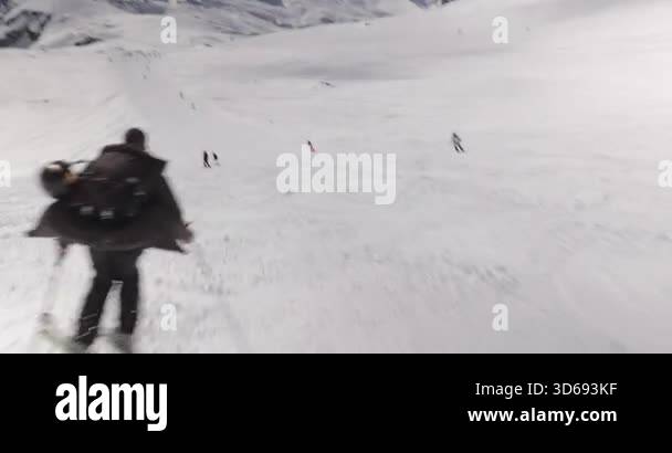 Skiing in the Alps, skier going fast descend, dynamic follow shot on ...