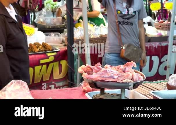 Vibrant market scene with raw meat display Stock Video Footage - Alamy