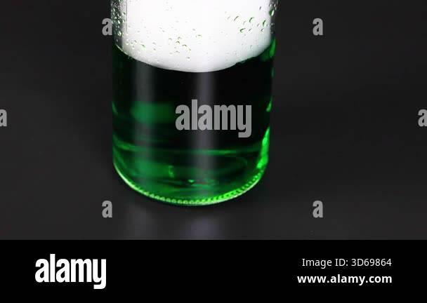 A beaker with green liquid reacts with dry ice, creating bubbling and ...