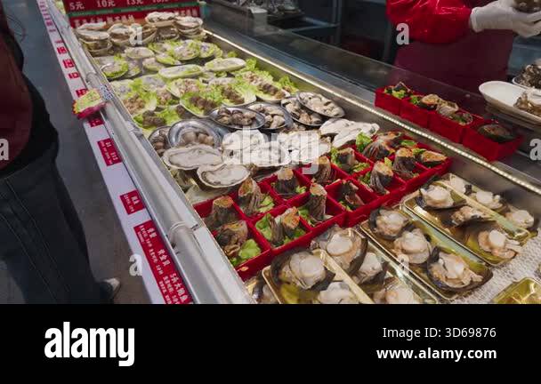 Various hot pot ingredients displayed in refrigerated cabinets at self ...