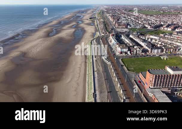 Coastal landscape features sandy beach stretching along the shore with ...