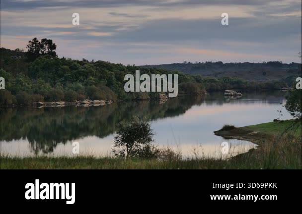 Evening lake landscape. Timelapse of clouds moving over water, light ...