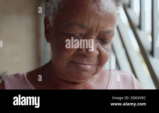 Close-Up Of Elderly Woman Looking Down With Reflexive Expression, Face ...